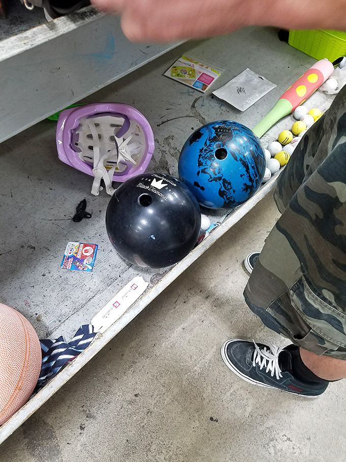 Bowling balls and sports equipment await their next game night hero&mdash;proof that one person's abandoned hobby is another's weekend passion.