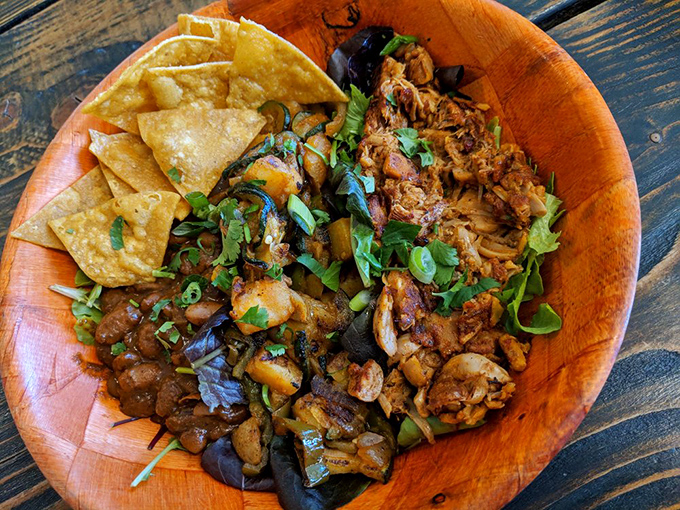 A wooden bowl that doesn't just contain food but tells a story of textures, colors, and the plant kingdom showing off its range.