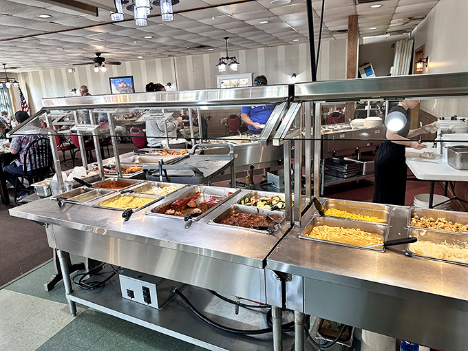 The buffet line gleams with stainless steel warmers protecting treasures more valuable than gold: home-cooked Amish specialties that defy mass production.