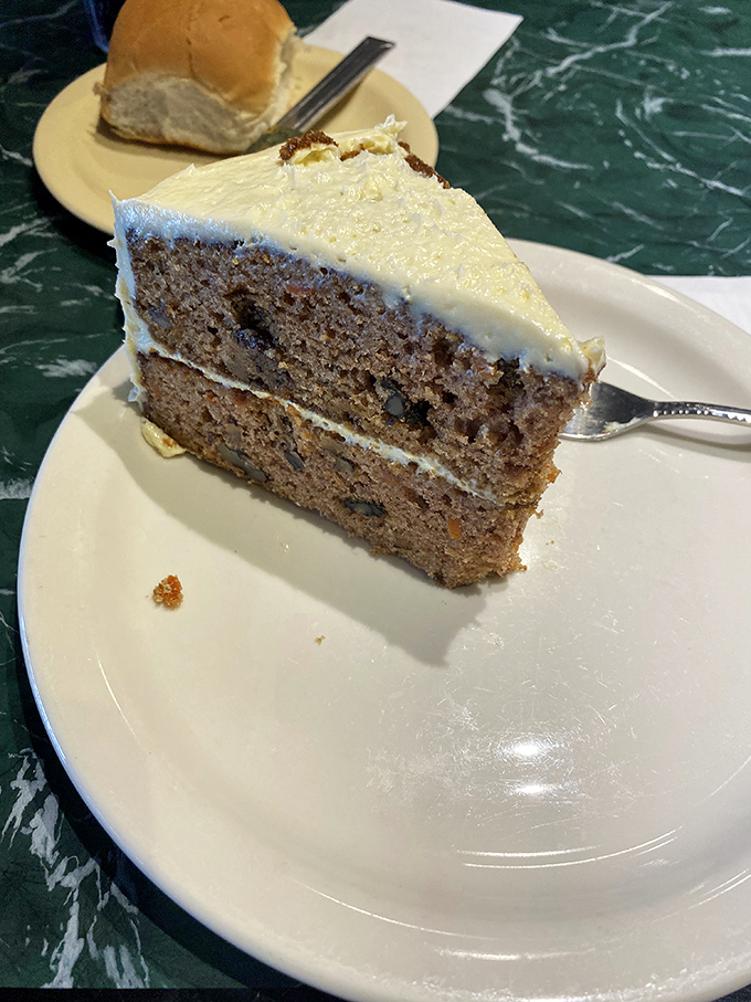 Carrot cake that clearly didn't skimp on the cream cheese frosting. Each layer tells a story of someone who understands dessert is serious business.