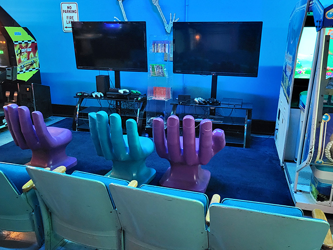 The modern gaming lounge area, where hand-shaped chairs prove that comfort and whimsy aren't mutually exclusive in the arcade experience.
