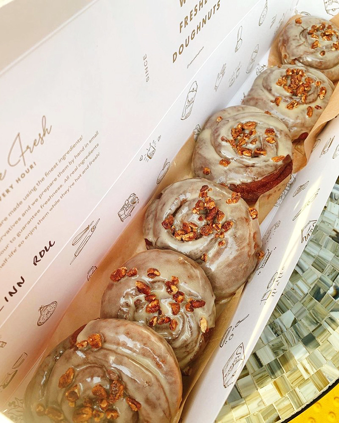 Cinnamon rolls lined up like sweet soldiers ready for duty. The caramelized edges promise that perfect first bite experience.