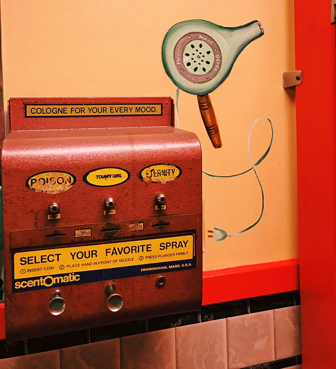"Select Your Favorite Spray"&mdash;a bathroom cologne dispenser that's survived decades, offering scents like "Poison" and "Eternity" for the discerning diner patron.