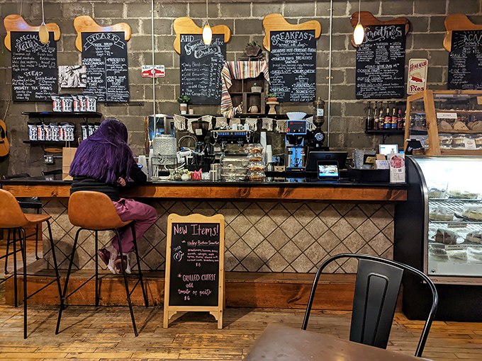 The command center of caffeine and confections, where baristas work their magic against a backdrop of handwritten menu boards.