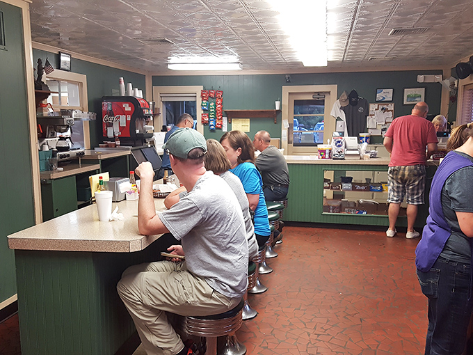 The counter area buzzes with anticipation as regulars perch on stools, watching the choreographed dance of service with knowing smiles.