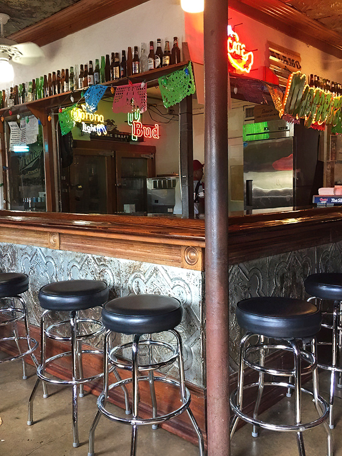 Neon beer signs, colorful papel picado, and a well-worn wooden bar create the perfect backdrop for pre-burger anticipation.