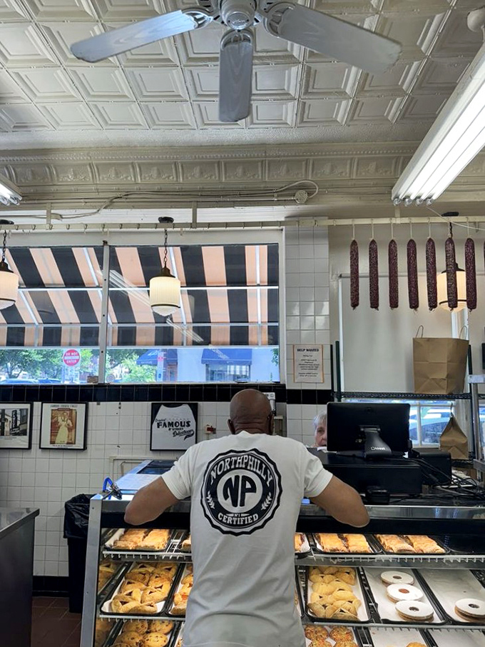 Behind the counter magic happens&mdash;where pastries tempt from below and salamis hang like delicious stalactites from a cave of culinary wonders.