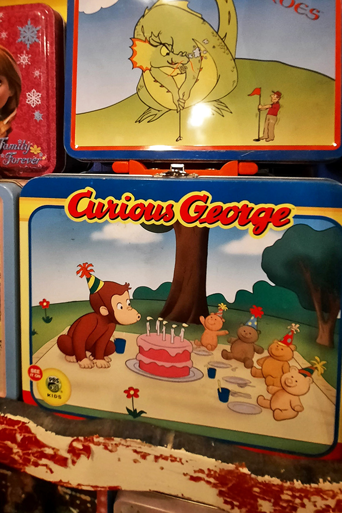 Curious George celebrates with friends in this pristine lunchbox that survived decades without a single banana smear or juice box explosion.