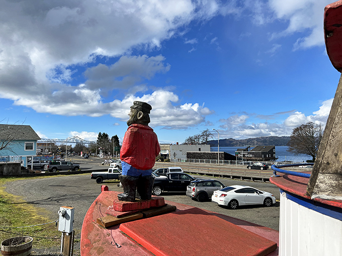 The carved sailor stands guard atop the Bowpicker, a wooden sentinel watching over Astoria's most precious culinary treasure.