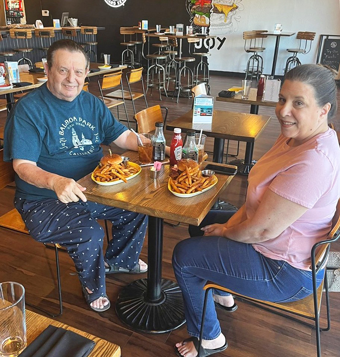 Happy diners proving that great food brings people together&mdash;nothing builds community quite like shared french fry appreciation.