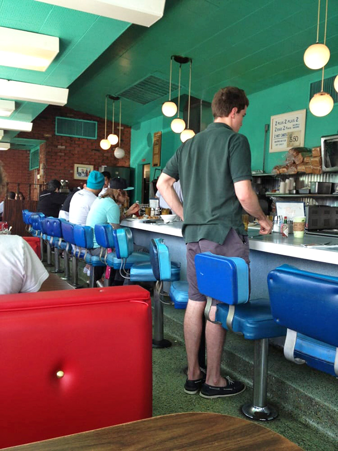 The blue counter stools aren't just seating&mdash;they're front-row tickets to the greatest show on earth: breakfast being made while you sip your coffee.