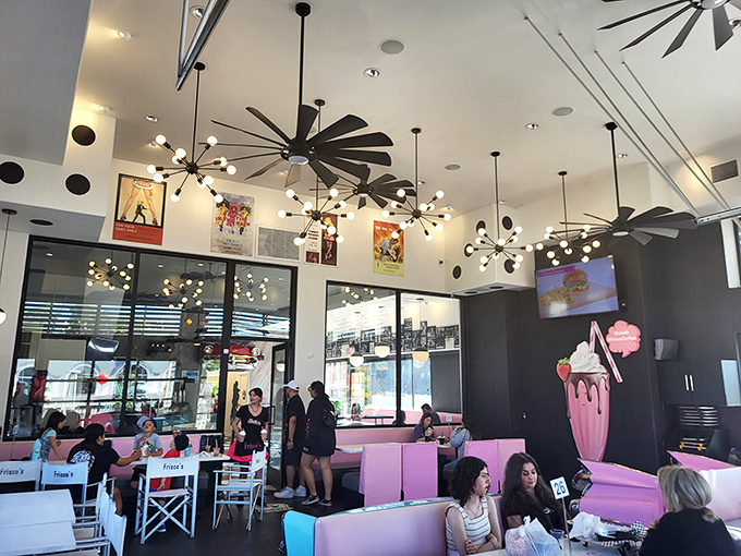 The dining room buzzes with the energy of happy eaters under those spectacular atomic-age light fixtures. Even the ceiling fans look like they're having fun.