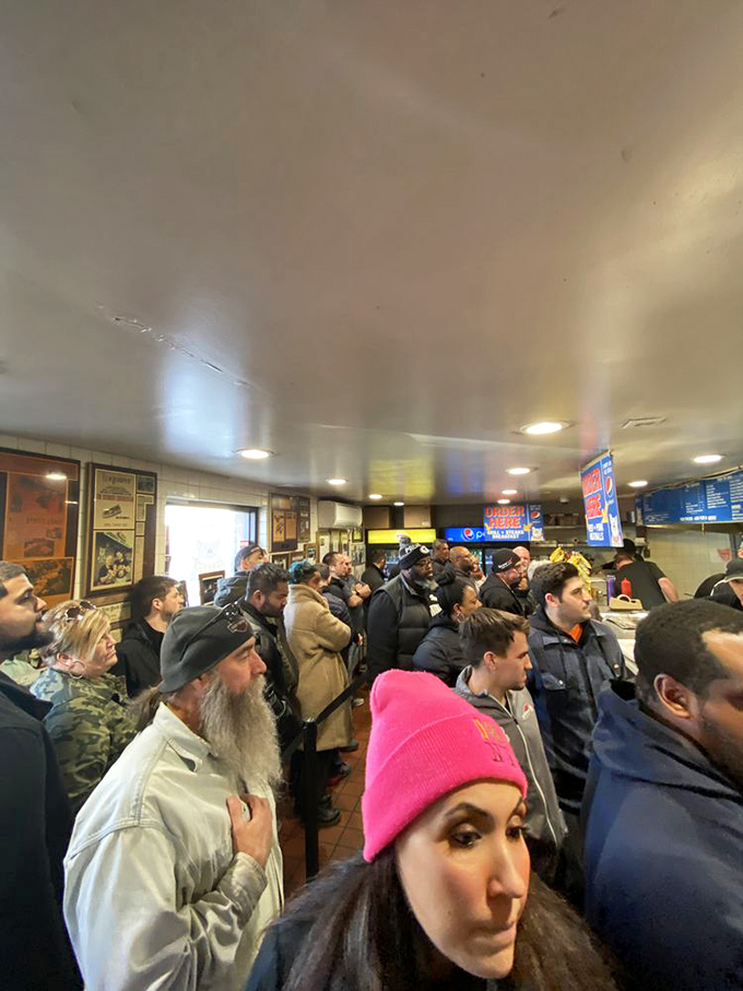 The line isn't a deterrent; it's a community of pilgrims united in pursuit of sandwich transcendence, each face a study in anticipation.