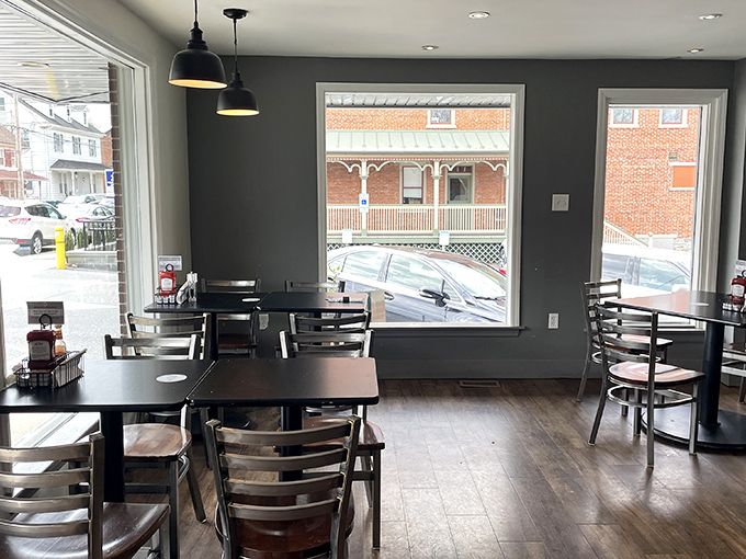 Gray walls and large windows create the perfect backdrop for morning conversations that stretch into afternoon without anyone noticing the time.