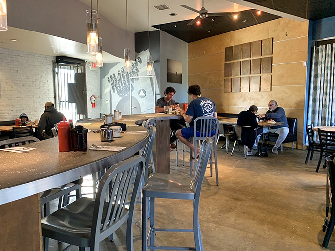The dining counter offers front-row seats to the breakfast theater, where pancake flipping becomes performance art.