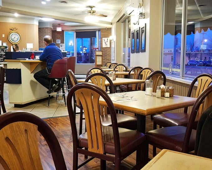 Morning light streams through windows illuminating a dining room where strangers become neighbors over shared appreciation of breakfast done right.