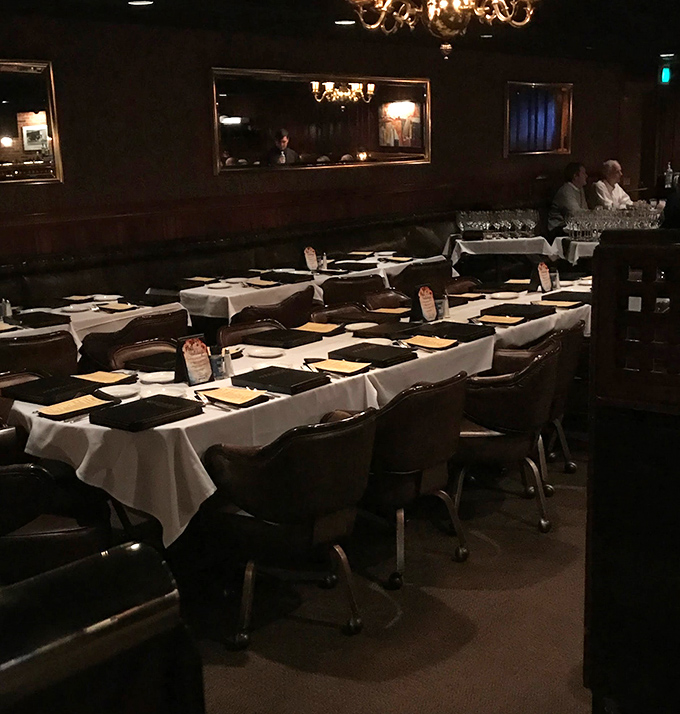 Tables set with anticipation, awaiting the evening's guests. White tablecloths: the canvas upon which culinary memories are painted.