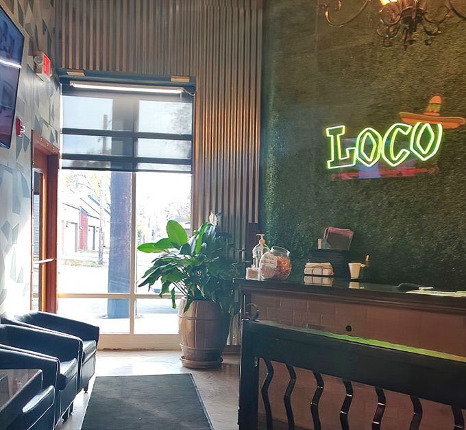 The entrance beckons with a glowing green sign and potted plants&mdash;like being invited into someone's stylish home, if that home served exceptional margaritas.