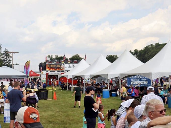 Festival season transforms quiet Utica into a bustling celebration where strangers become friends over shared plates and live music under summer skies.