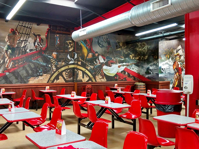 The food court's pirate-themed dining area, where treasure hunting meets refueling. Those red chairs have supported countless bargain-seekers' brief respites.