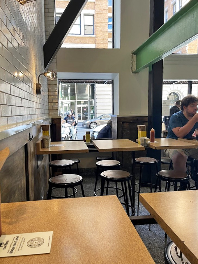 High ceilings, white subway tiles, and natural light pouring in - like someone designed a cathedral but dedicated it to fried chicken instead.