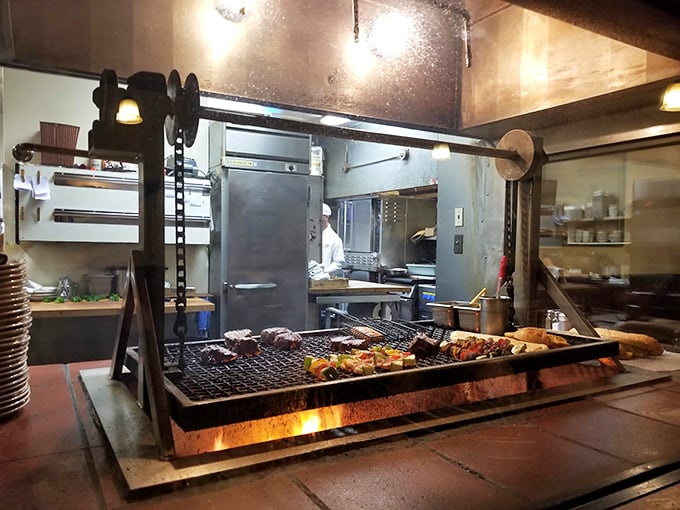 The heart of the operation: Santa Maria-style oak grilling on full display, where steaks meet flame in a ritual as old as California ranching.