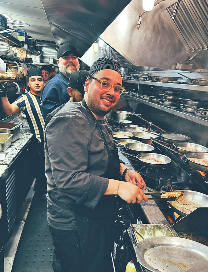 The kitchen reveals the wizards behind the curtain, working their culinary magic with the focus of neurosurgeons and joy of artists.