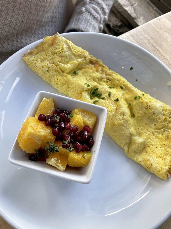 An omelet so perfectly executed it deserves its own cooking show, with a side of fruit that didn't just phone in its performance.