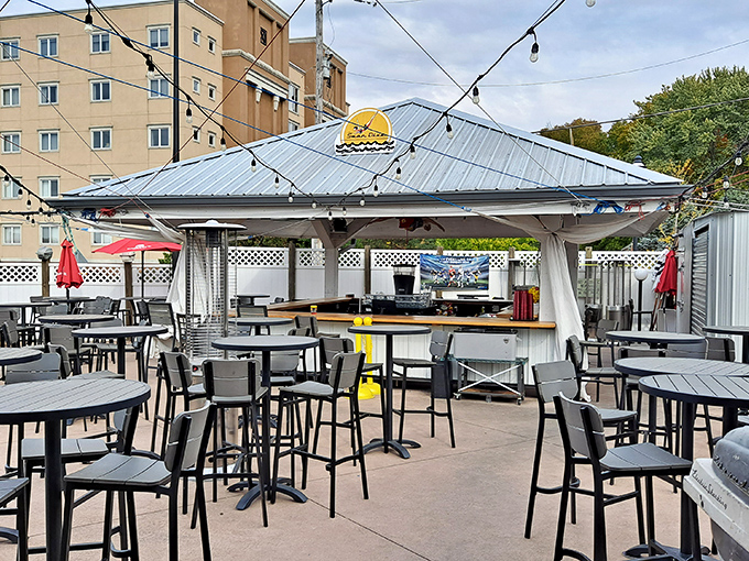 The outdoor bar stands ready for sunset service, where cocktails taste better under string lights and with a gentle lake breeze.