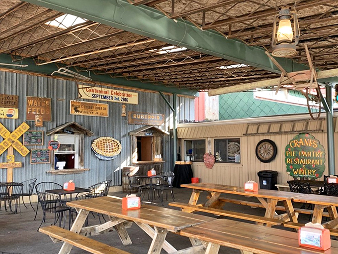 The covered outdoor seating area invites you to linger longer, where picnic tables and vintage signs create the perfect backdrop for pie-induced happiness.