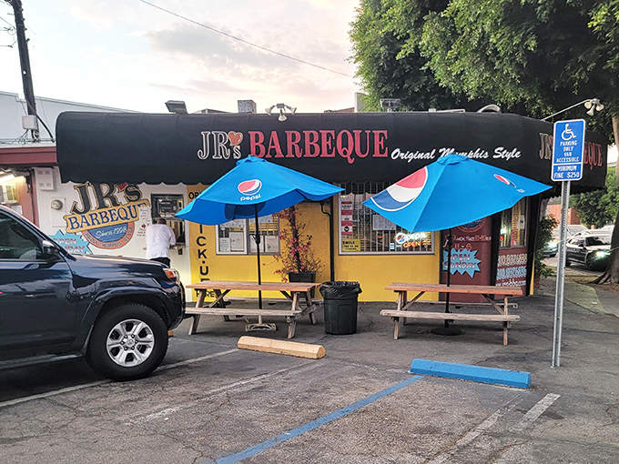 Al fresco dining, barbecue-joint style. Those blue umbrellas have sheltered more food epiphanies than all the Michelin-starred patios combined.
