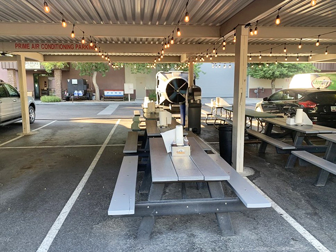 The outdoor seating area, where Arizona evenings and barbecue create memories under string lights. Simple tables, extraordinary experiences.