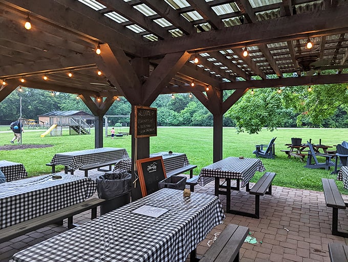Al fresco dining with checkered tablecloths under a rustic pavilion&mdash;because sometimes Mother Nature makes the best dining companion.