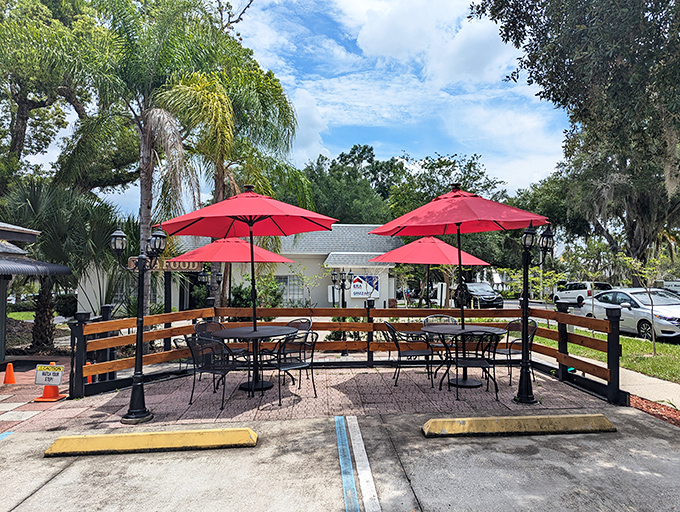 Al fresco dining under red umbrellas transforms a simple meal into a proper Florida seafood celebration experience.