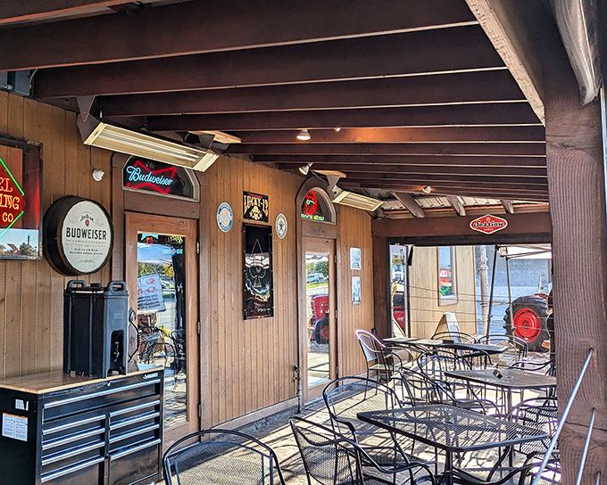 The outdoor seating area feels like the backyard of that cool uncle who always had the best barbecues. Beer signs included.
