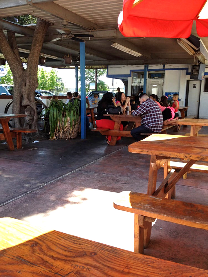 The covered patio area offers a shady respite from the Central Valley heat, with picnic tables that have witnessed countless first dates and family outings.