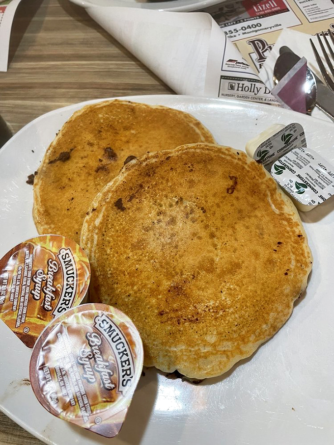 Pancakes so fluffy they practically hover above the plate. The butter melts into little pools of breakfast bliss.