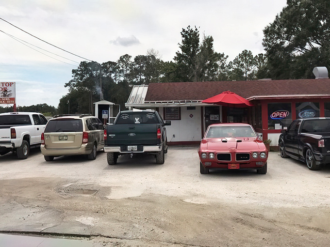 The parking lot tells the real story: trucks, cars, and even a classic Pontiac all gathered like faithful worshippers at the altar of good eating.