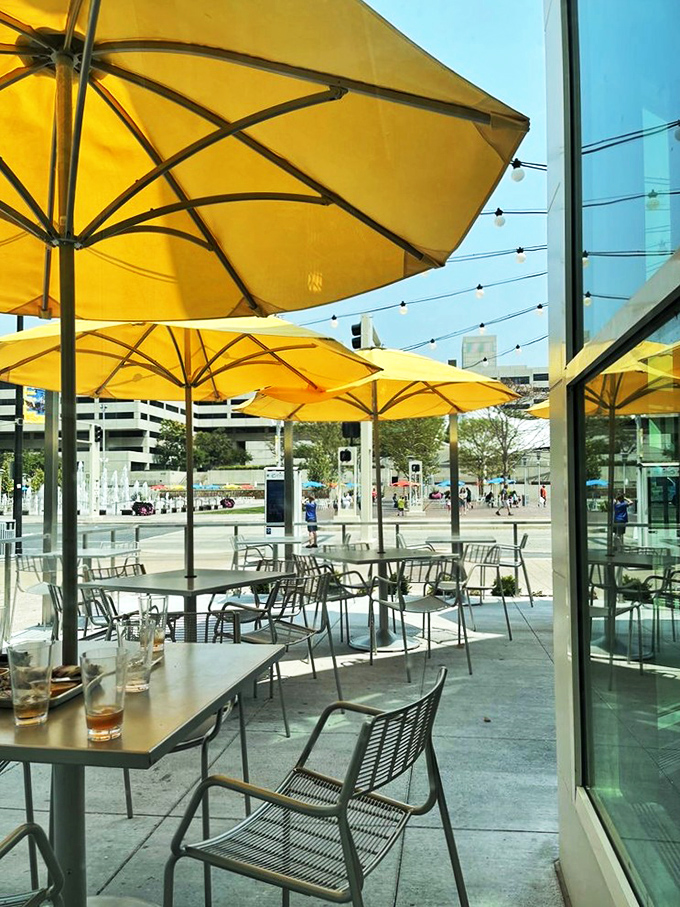 Outdoor dining under Kansas City skies. Those yellow umbrellas aren't just for shade &ndash; they're signaling to passing planes that paradise exists below.