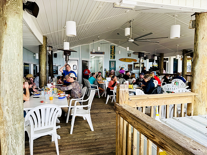 The covered patio where seafood meets sea breeze. Those wooden posts have witnessed more vacation memories than a disposable camera.