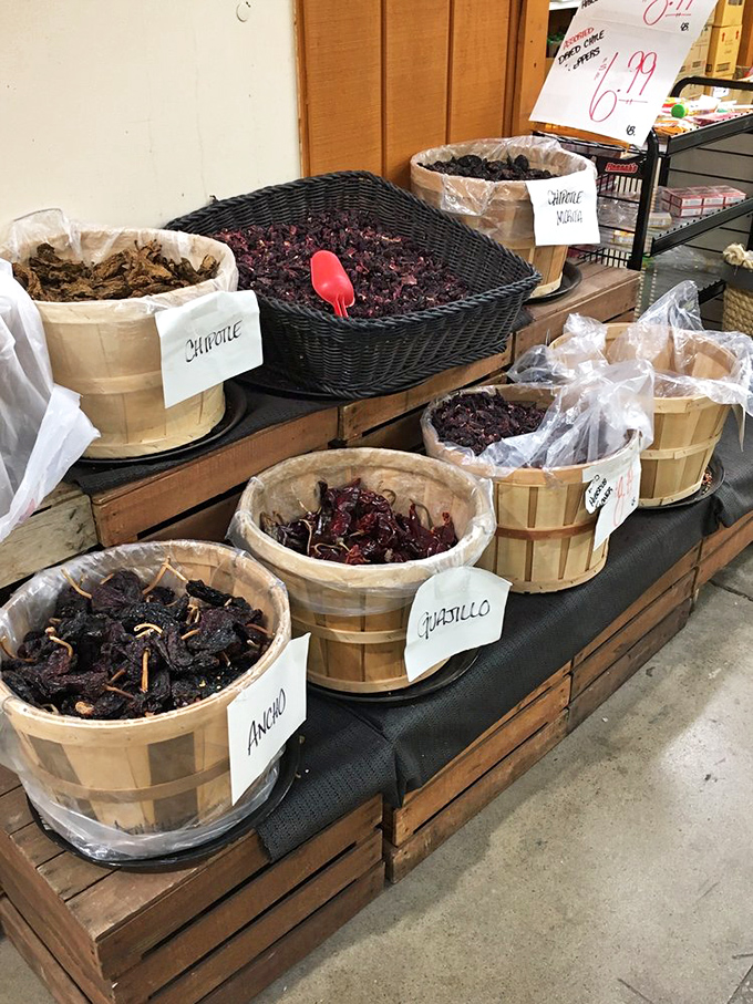 Dried pepper paradise! These wooden baskets hold a rainbow of dehydrated heat, with varieties labeled in elegant script that belies their fiery personalities.
