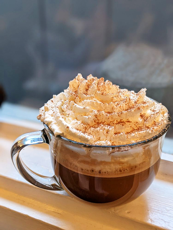 This isn't just coffee&mdash;it's a warm hug in a transparent mug, topped with cinnamon-dusted whipped cream that defies gravity and expectations.