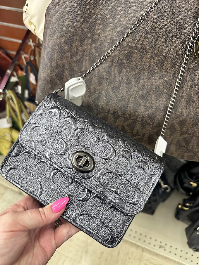 Designer purses hiding in plain sight! This Coach crossbody with its signature pattern waits for the eagle-eyed shopper to spot its authentic charm.