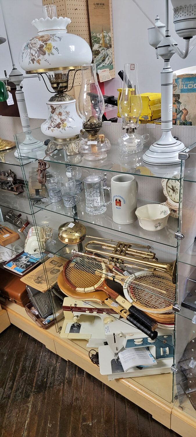 Delicate lampshades and elegant glassware sharing space with everyday mugs&mdash;exactly the kind of democratic jumble that makes antiquing a treasure hunt for everyone.