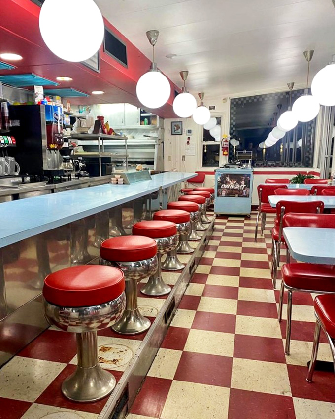 The red and white checkerboard floor isn't just nostalgic—it's practically the official passport stamp of authentic American diners. Those stools have heard every story in town.