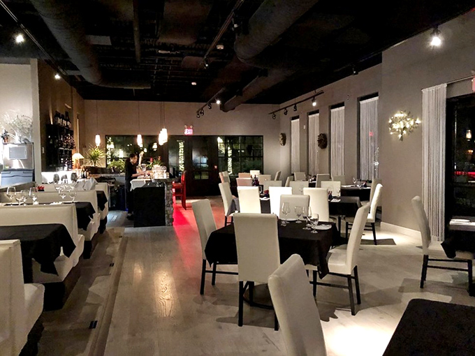 Dining room elegance that whispers "special occasion" without shouting "pretentious." Those crisp white chairs aren't just seating—they're front-row tickets to a culinary performance.