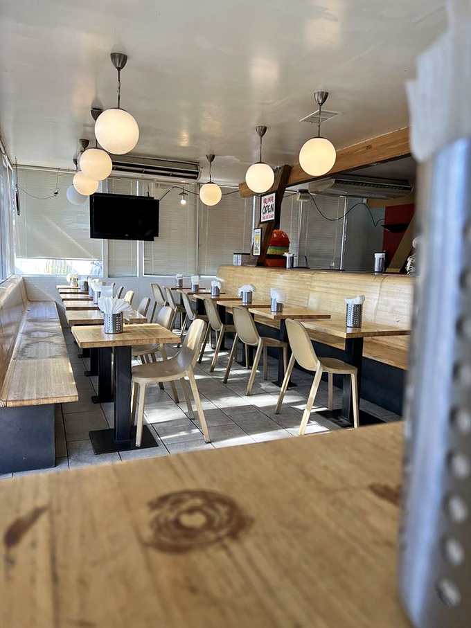 Modern pendant lights illuminate wooden tables where memories are made between bites. Simple, clean, and focused on what matters.