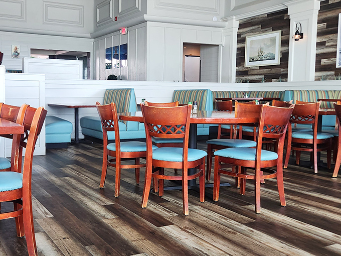 Turquoise chairs and warm wood create that perfect "coastal casual" atmosphere where flip-flops and special occasions equally belong.