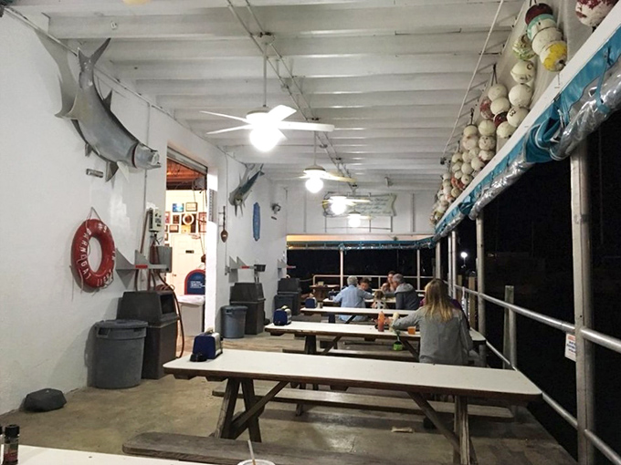 Evening dining under fishing trophies and buoys. The maritime decor isn't from a designer catalog—it's the real deal from decades on the water.