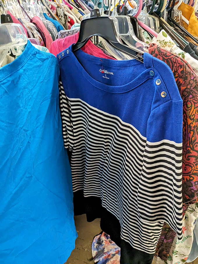 The clothing racks reveal treasures like this blue and striped top. Someone's "what was I thinking?" purchase becomes your new favorite shirt.